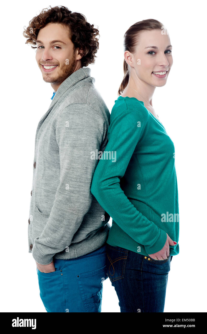 Fashion couple posing back to back Stock Photo - Alamy