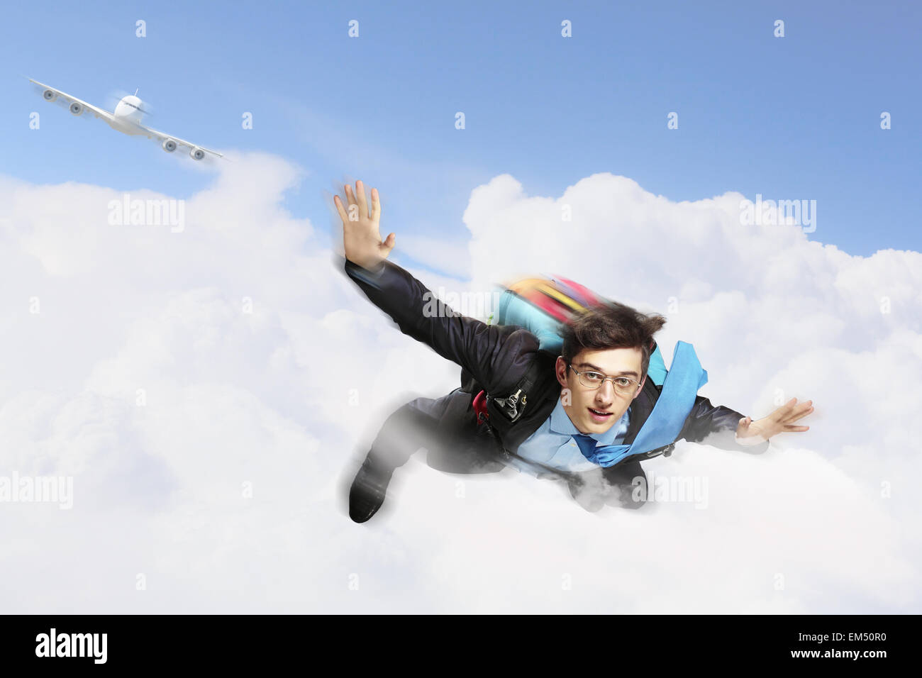 Young businessman flying with parachute on back Stock Photo - Alamy
