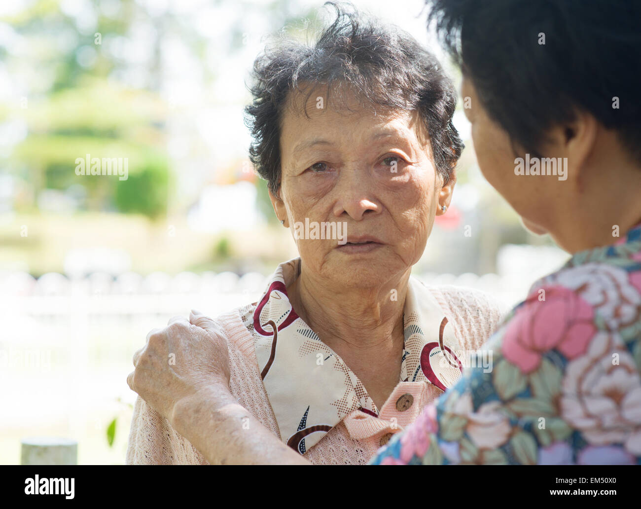 Person comforting crying asian woman hi-res stock photography and ...
