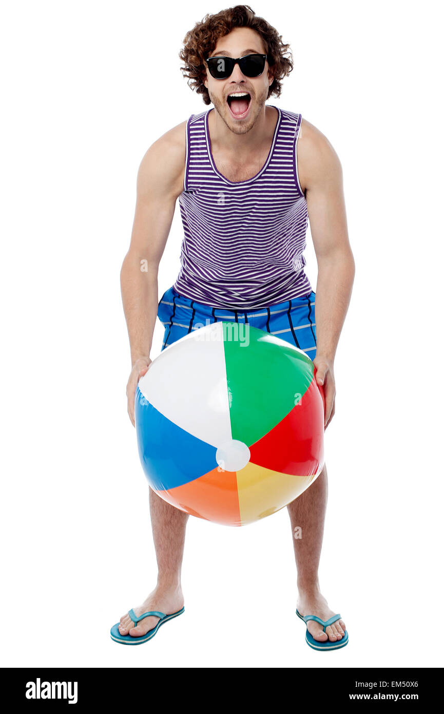 Cool guy playing with beach ball Stock Photo - Alamy