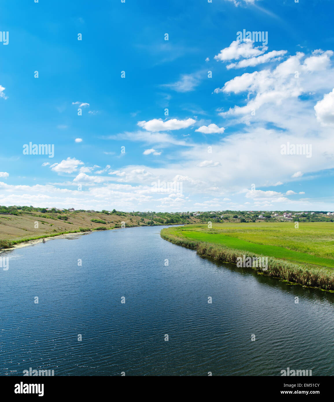 river with reflections and blue cloudy sky Stock Photo - Alamy