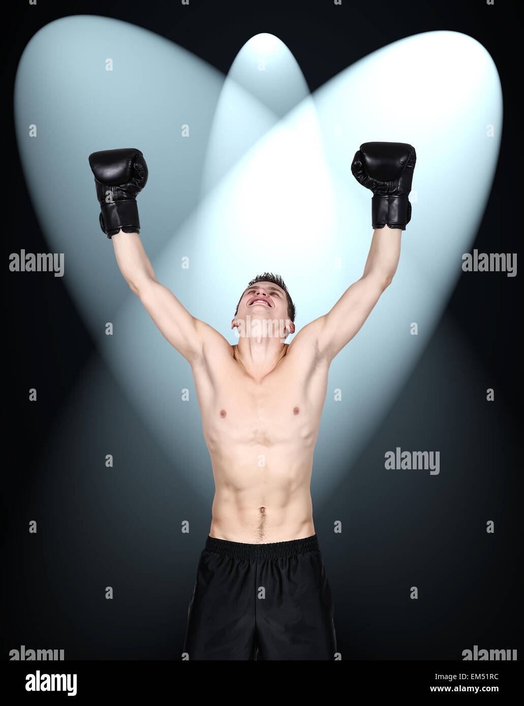 happy boxer winner under the rays of spotlight Stock Photo - Alamy