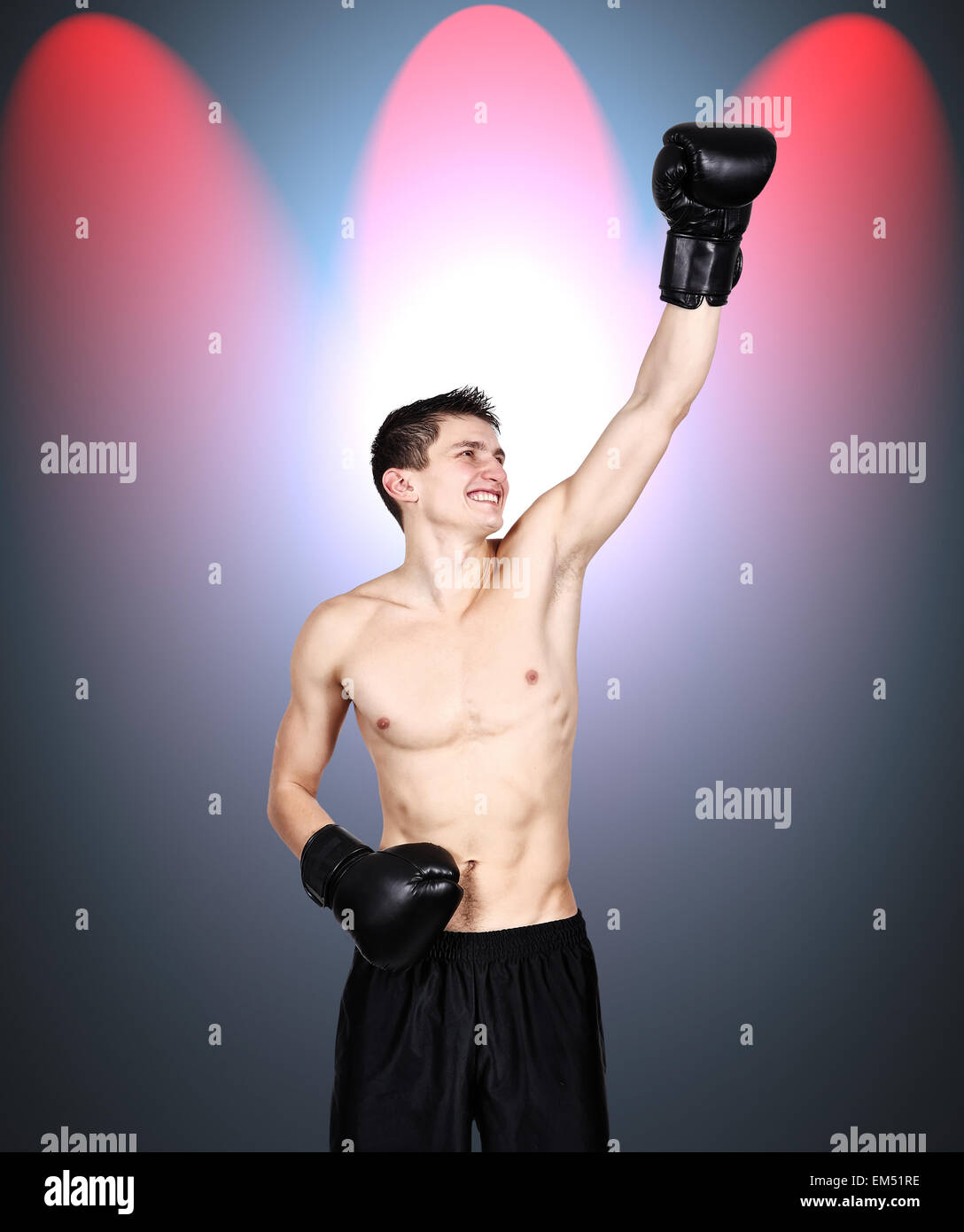 young boxer winner under the rays of spotlight Stock Photo - Alamy