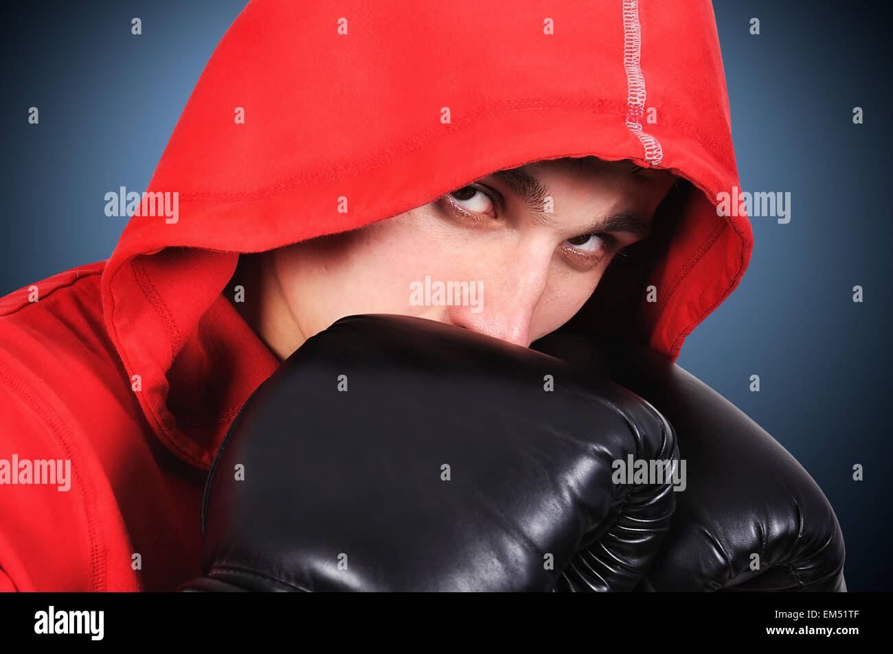 Young boxer man isolated on blue background Stock Photo - Alamy