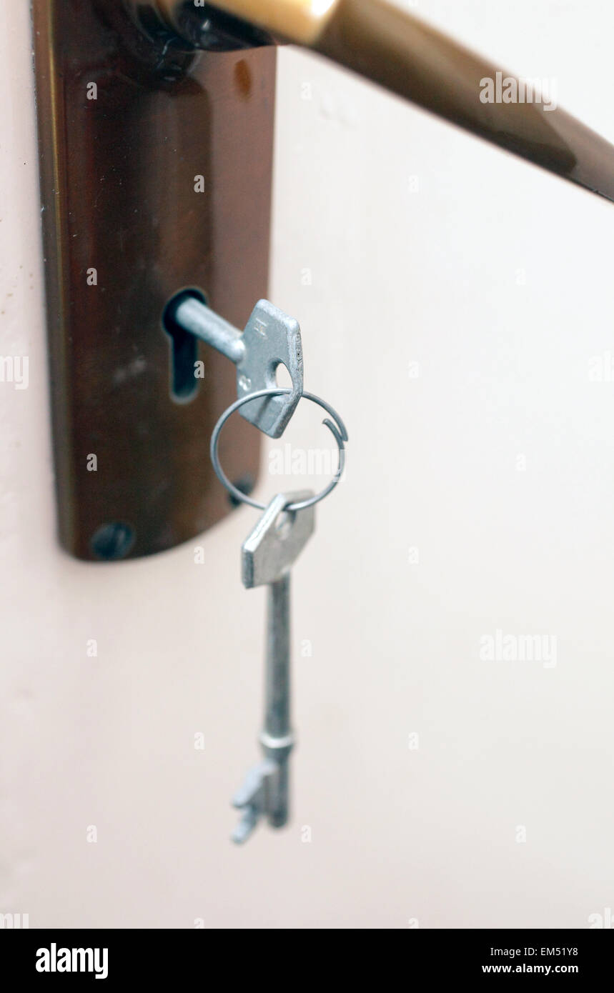 Keys hanging from the door Stock Photo - Alamy
