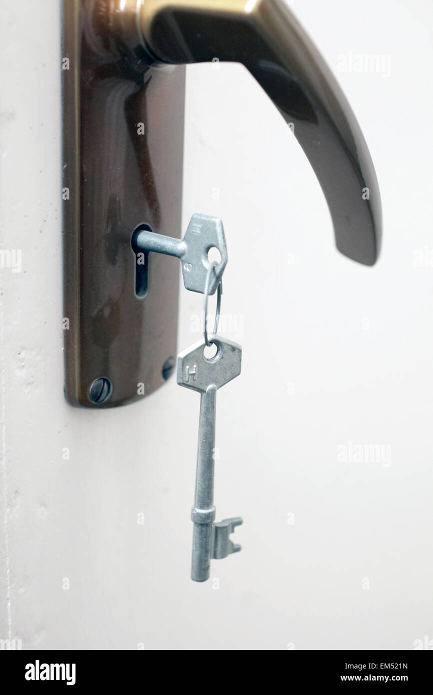 Keys in the door Stock Photo - Alamy