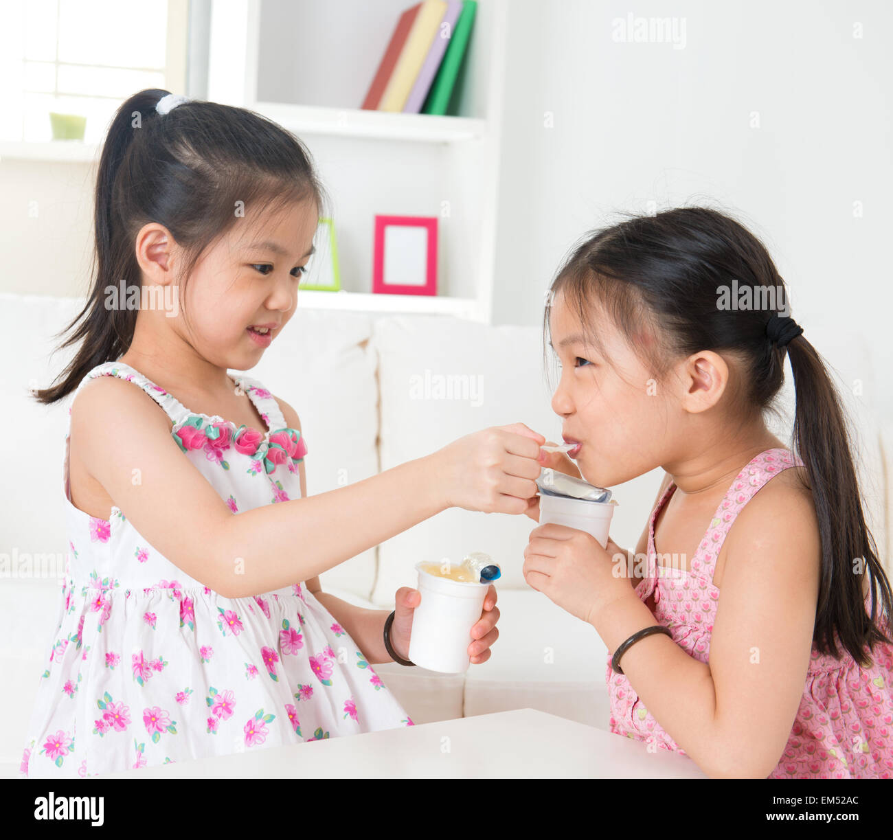 Eating yogurt happy asian children hi-res stock photography and images ...