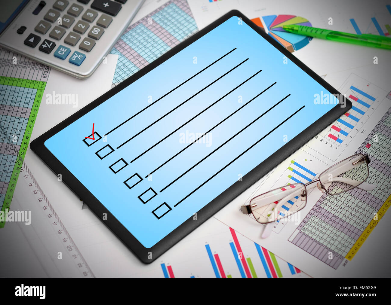 tablet with checklist and financial statements on table Stock Photo - Alamy