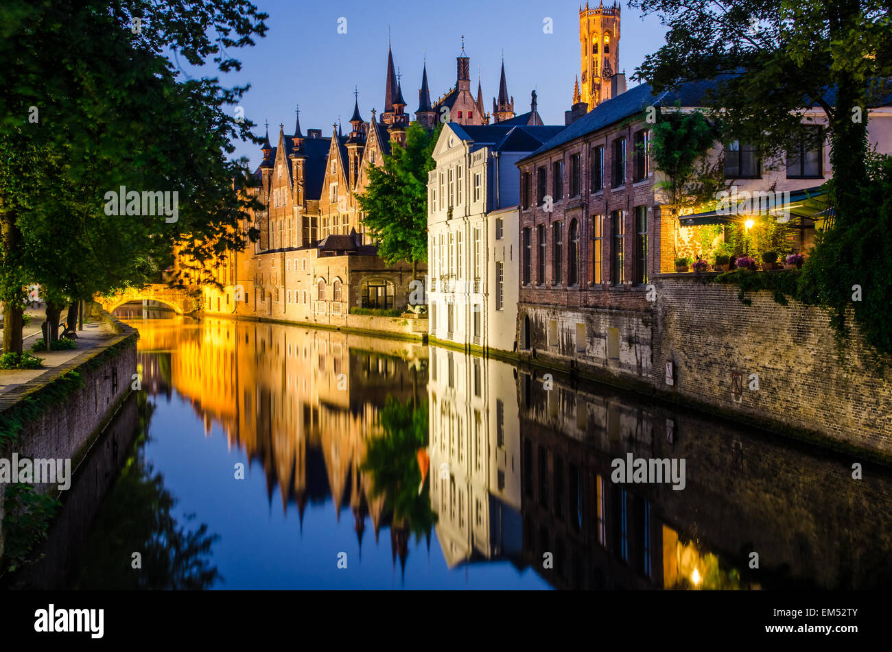 Water canal, medieval houses and bell tower at night in Bruges Stock ...