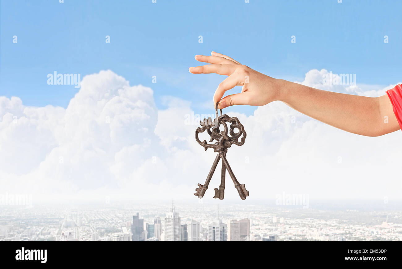 Hand holding keys Stock Photo - Alamy
