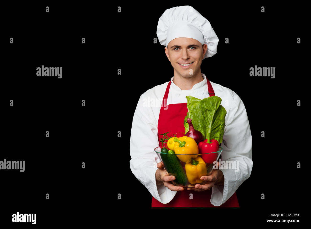 Handsome chef holding vegetables bowl Stock Photo - Alamy