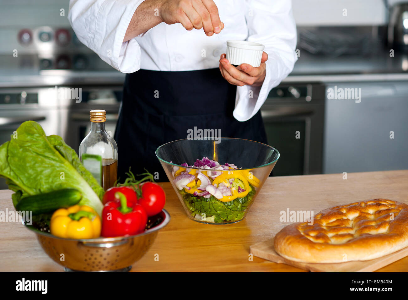 Chef sprinkling salt on vegetables Stock Photo - Alamy