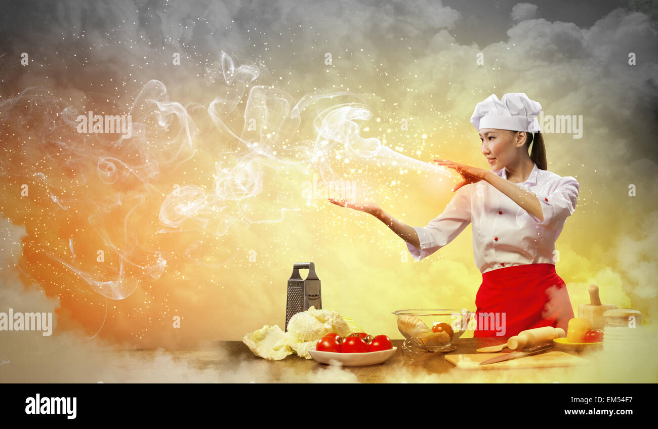 Asian female cooking with magic Stock Photo - Alamy
