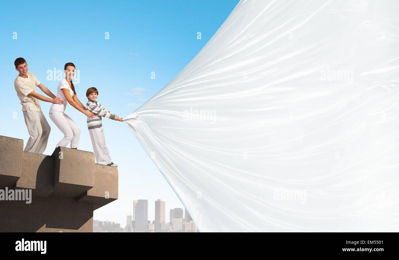Young family pulling banner Stock Photo - Alamy
