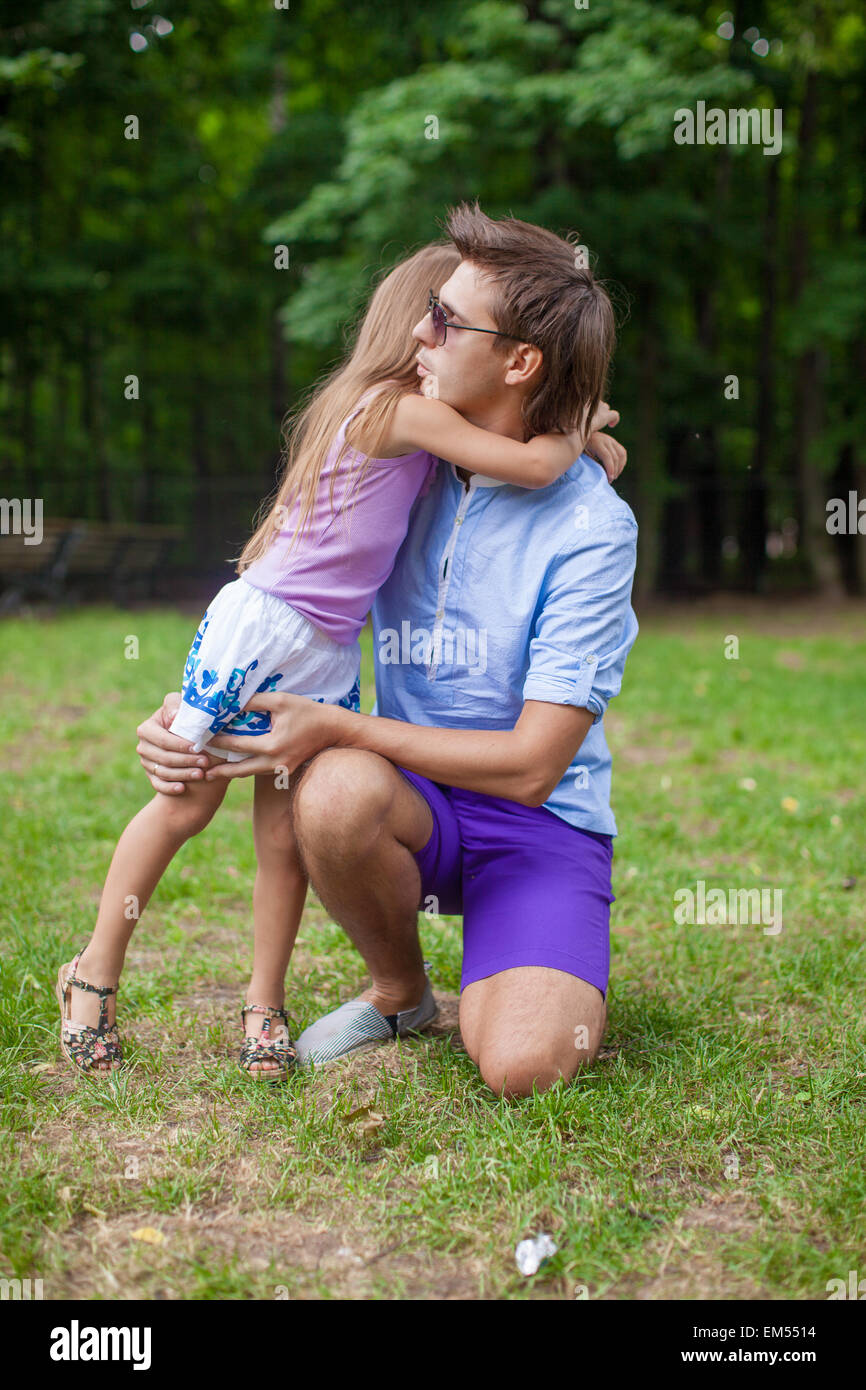 Young father hugging his little adorable daughter outdoors Stock Photo ...