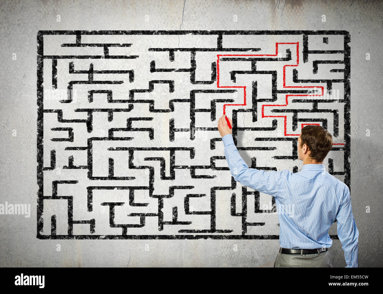 Businessman solving labyrinth problem Stock Photo - Alamy