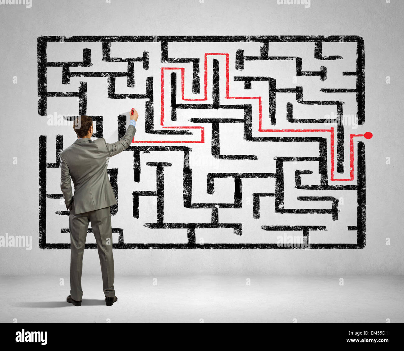 Businessman solving labyrinth problem Stock Photo - Alamy