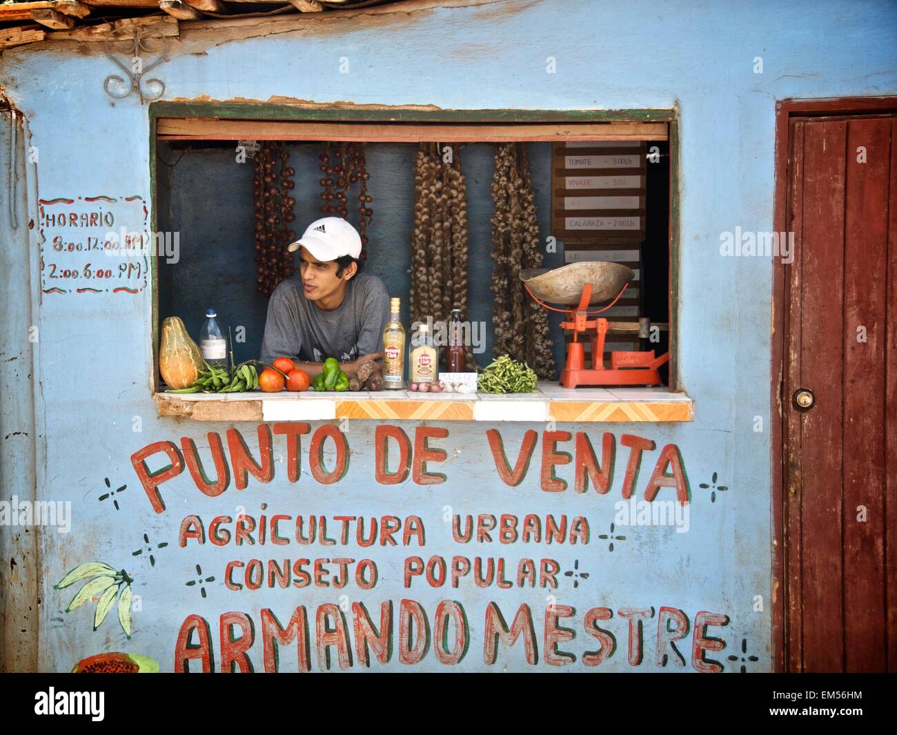 Private business expands in Cuba. A man stands behind the counter at ...