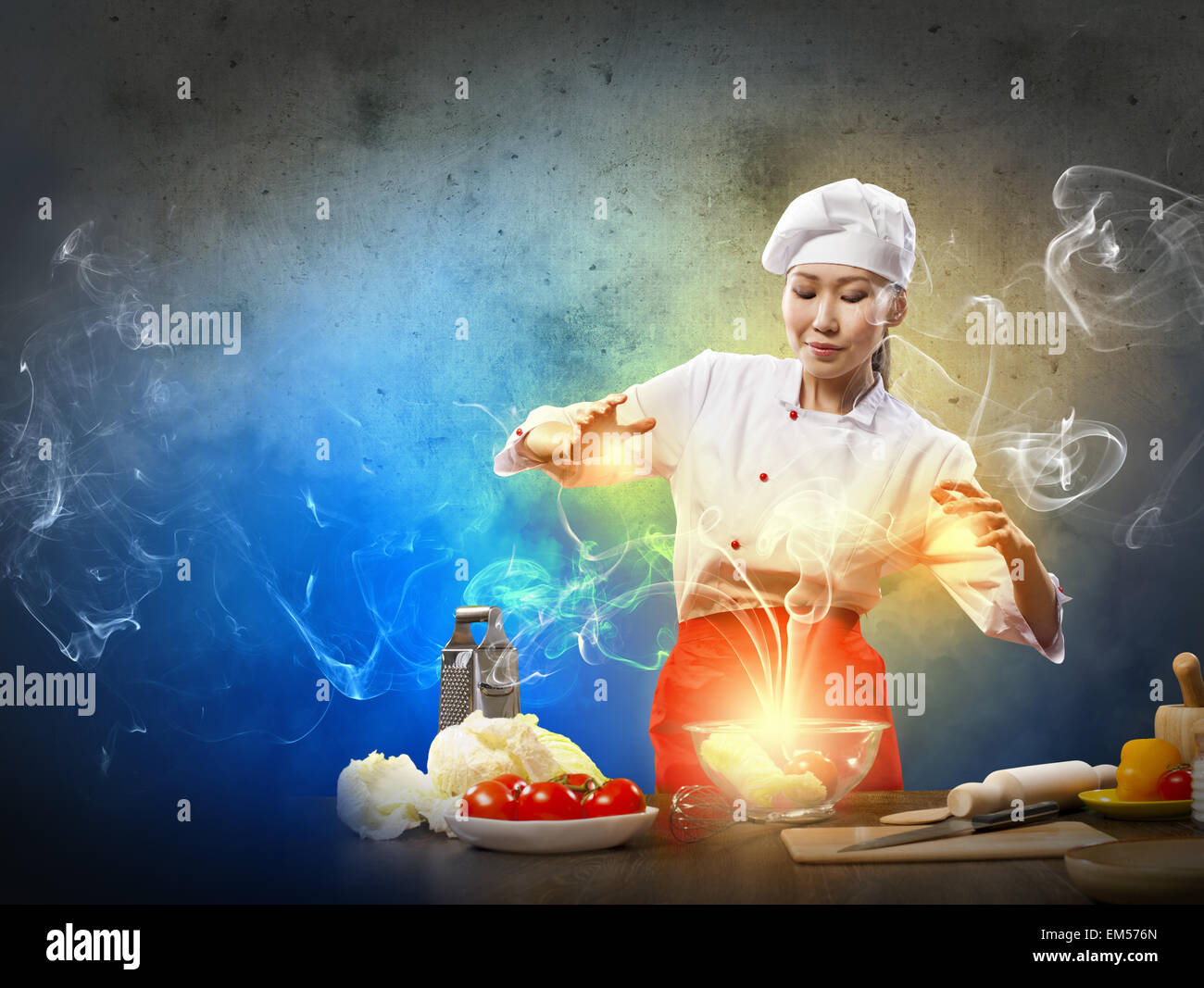Asian female cooking with magic Stock Photo - Alamy