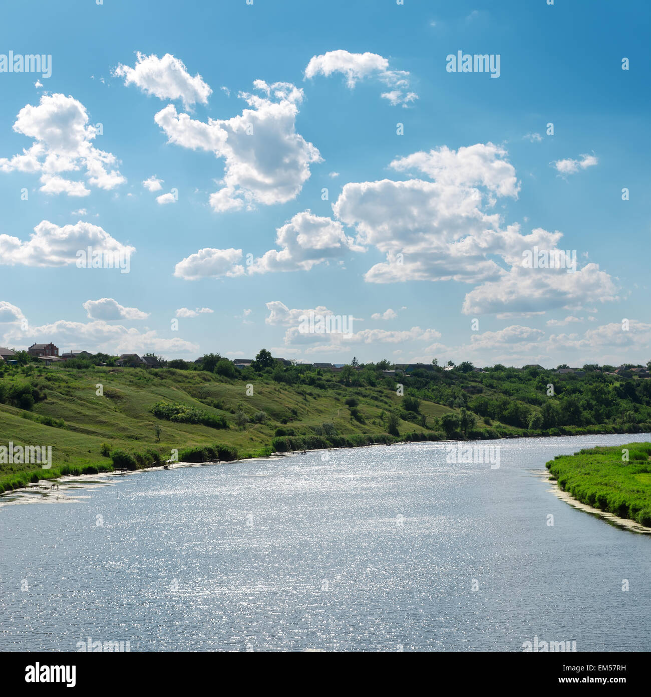 blue sky with clouds and river with reflections Stock Photo - Alamy