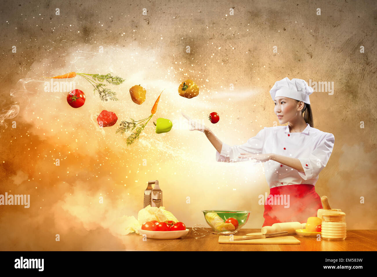 Asian female cooking with magic Stock Photo - Alamy