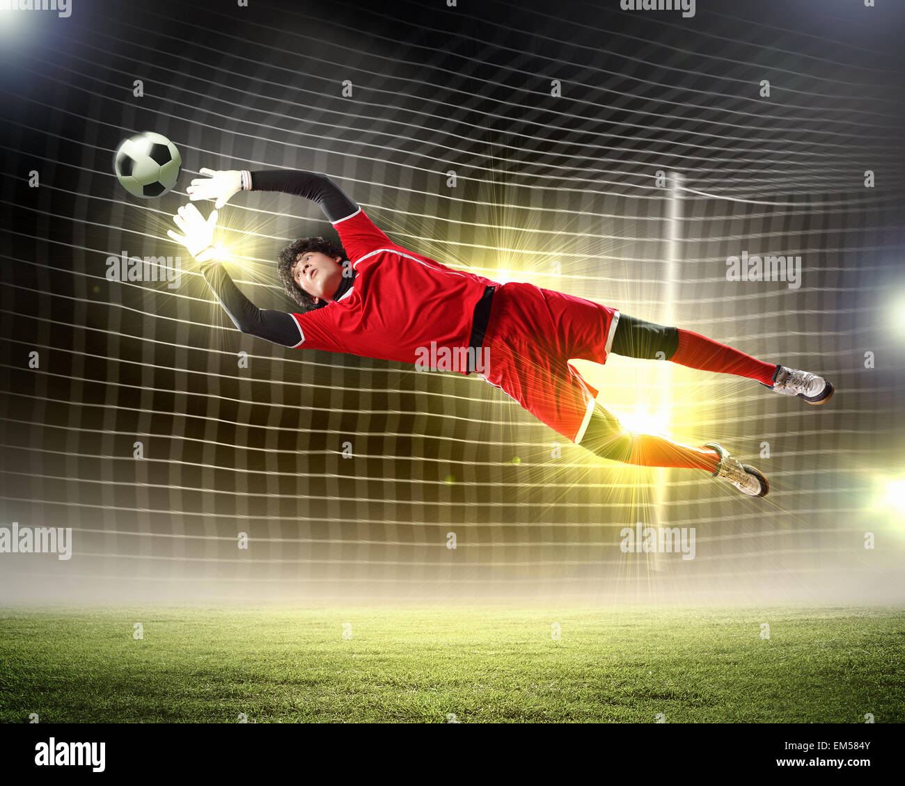 Goalkeeper catches the ball Stock Photo - Alamy
