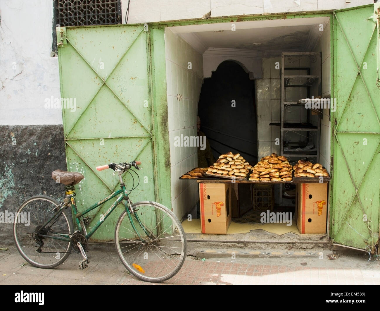 Morocco, Casablanca, Old Medina, Bread for sale in shop with bicycle ...