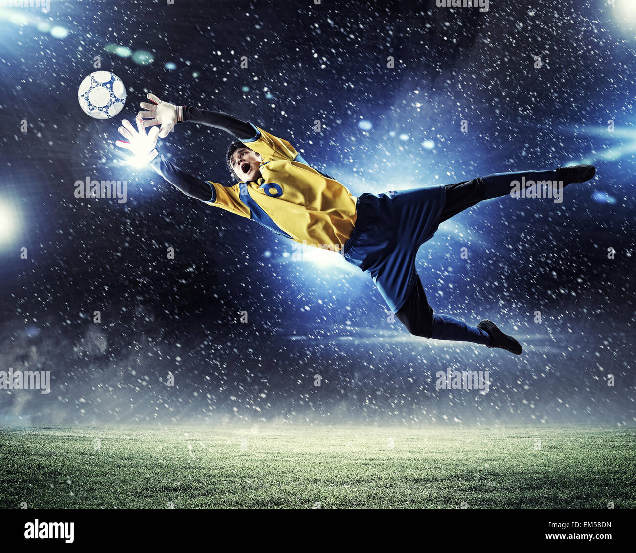Goalkeeper catches the ball Stock Photo - Alamy