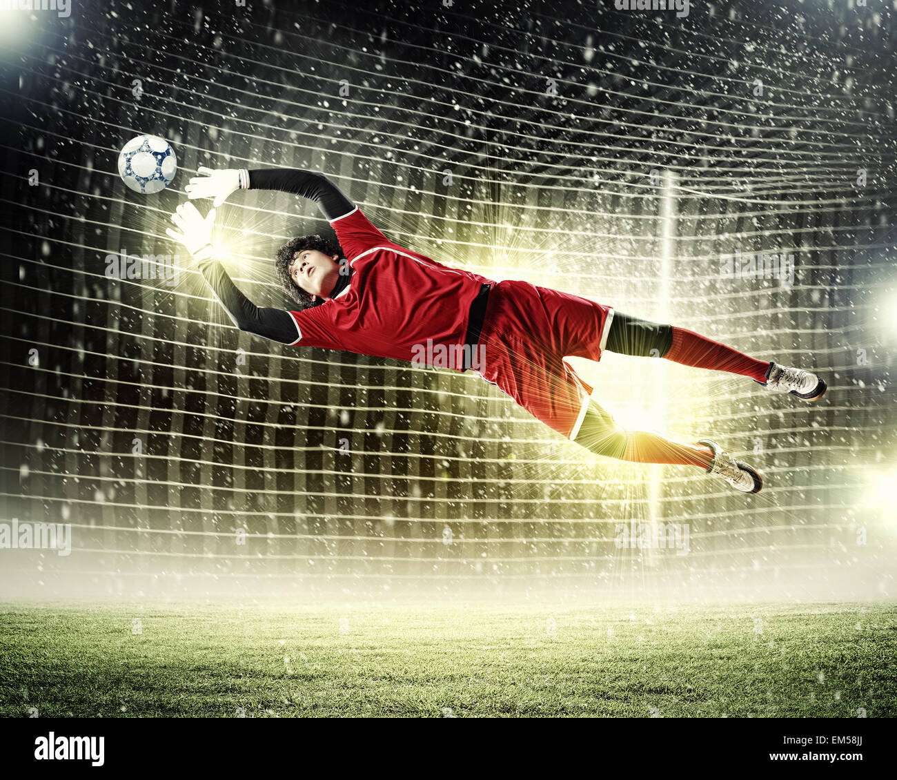 Goalkeeper catches the ball Stock Photo - Alamy