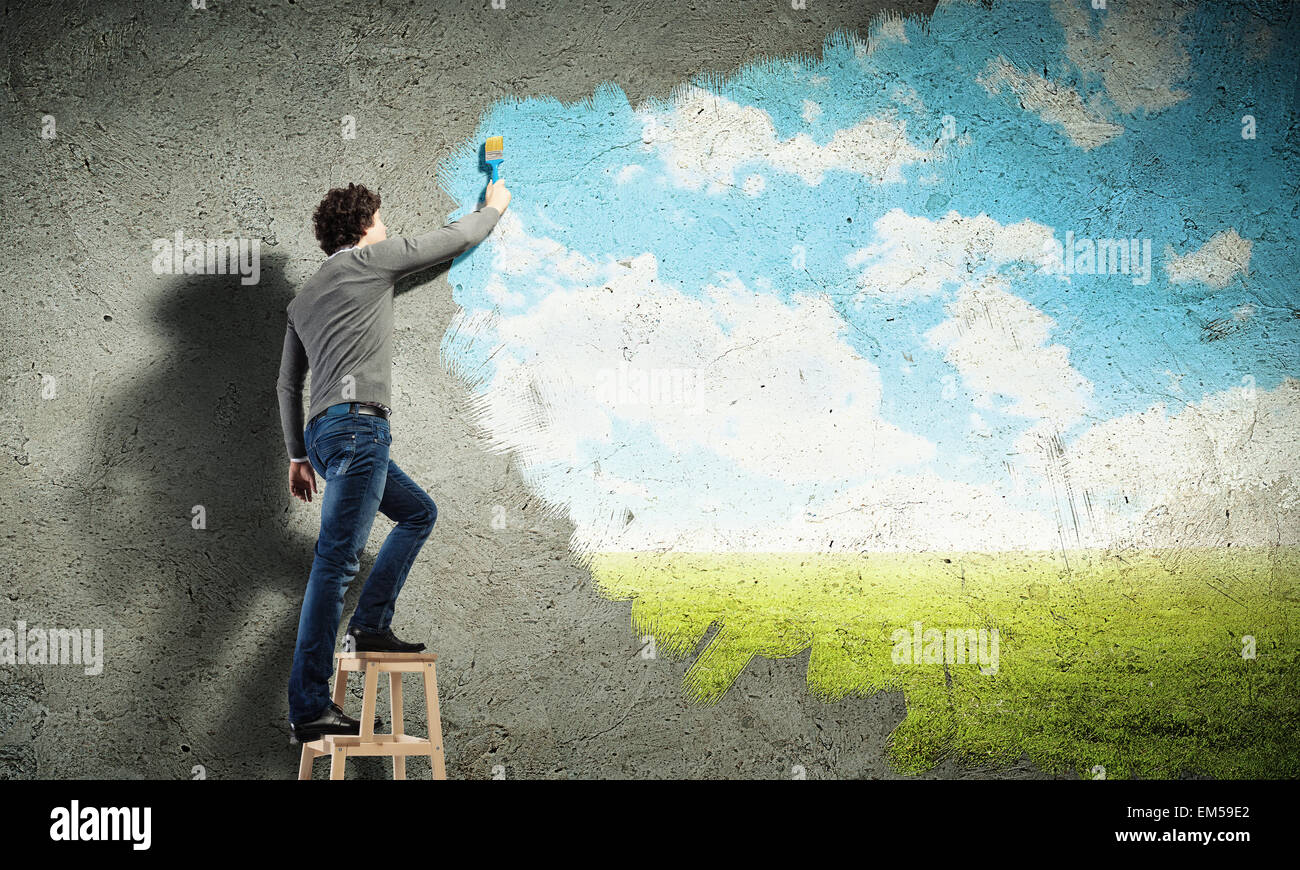 Young man drawing a cloudy blue sky Stock Photo - Alamy
