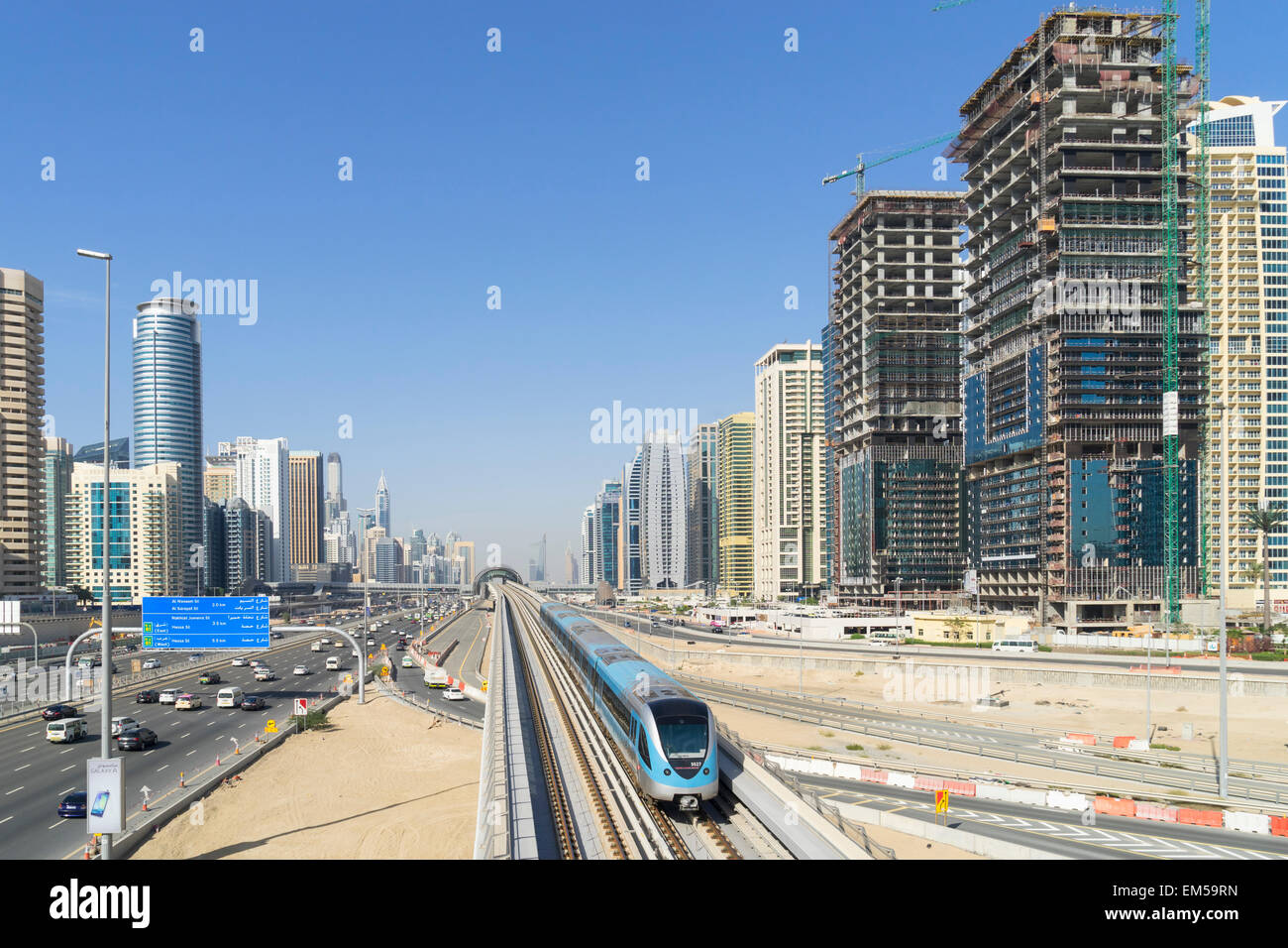 Metro train and skyline of Dubai at Jumeirah Lakes Towers (JLT) in ...