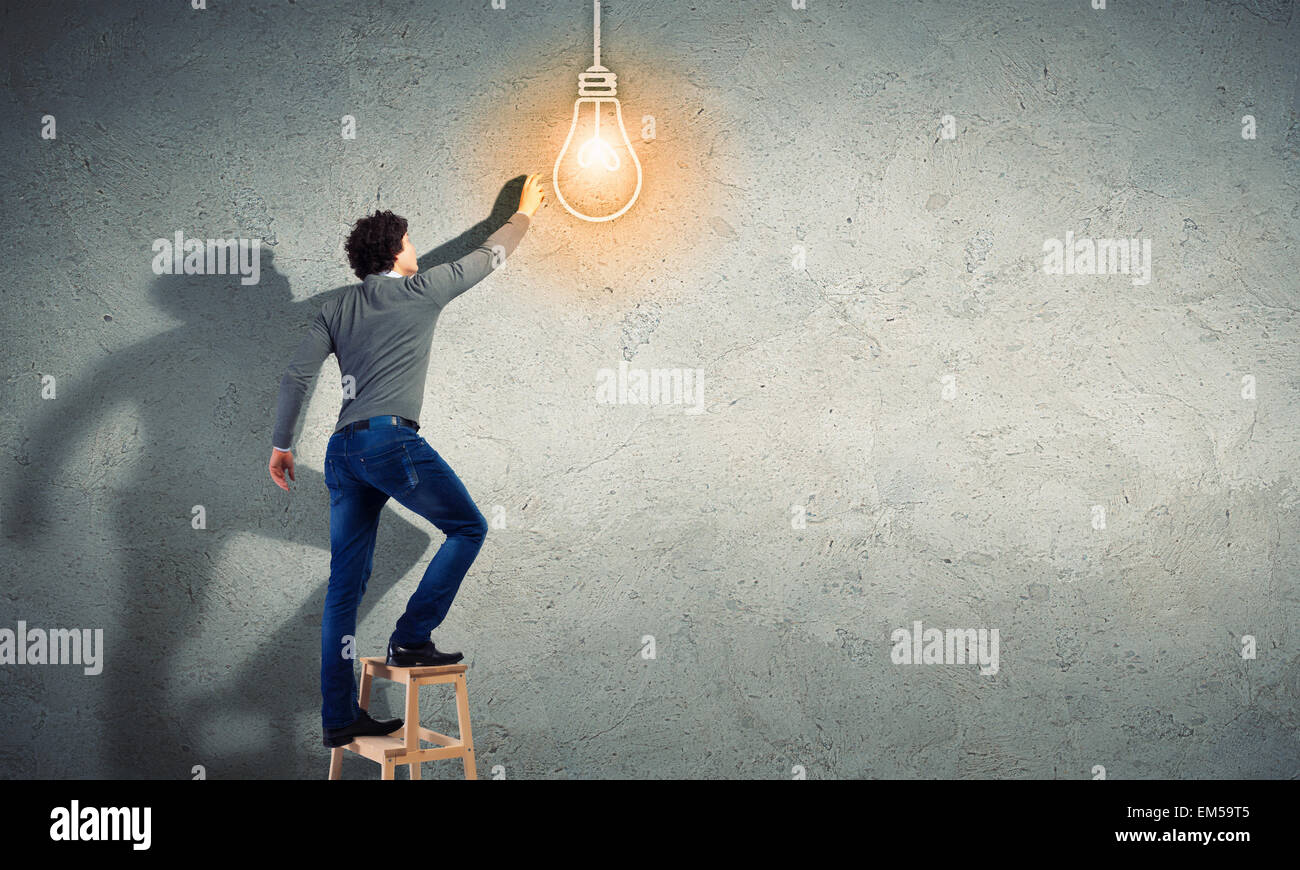 Young man with an electric light bulb Stock Photo - Alamy