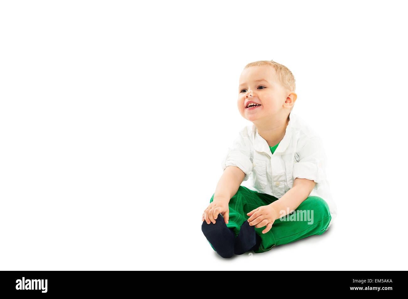 Adorable young boy holding his toe Stock Photo - Alamy