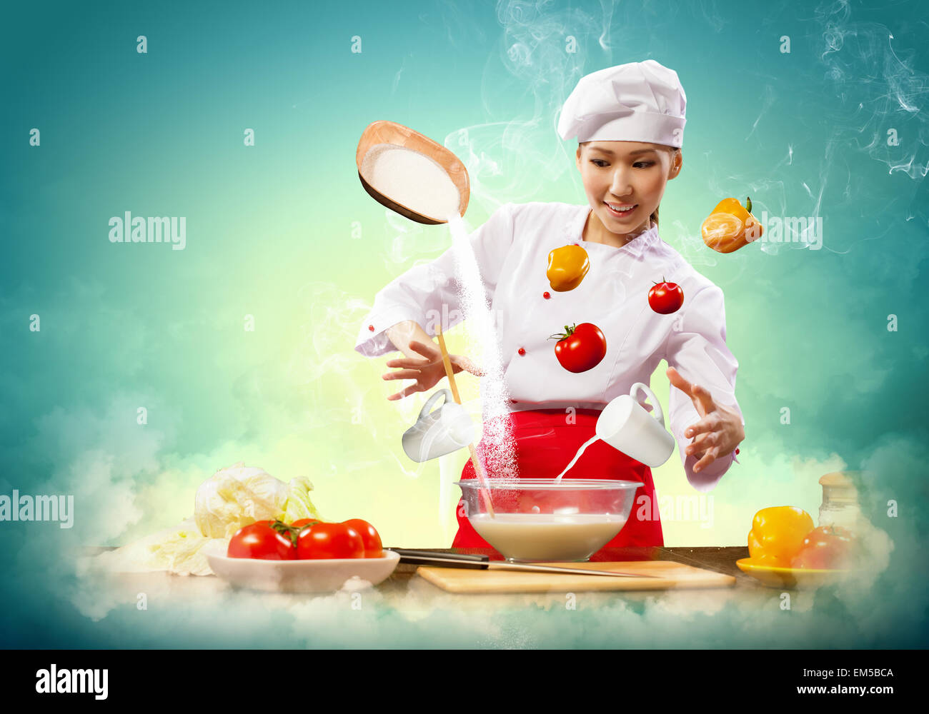 Asian female cooking with magic Stock Photo - Alamy