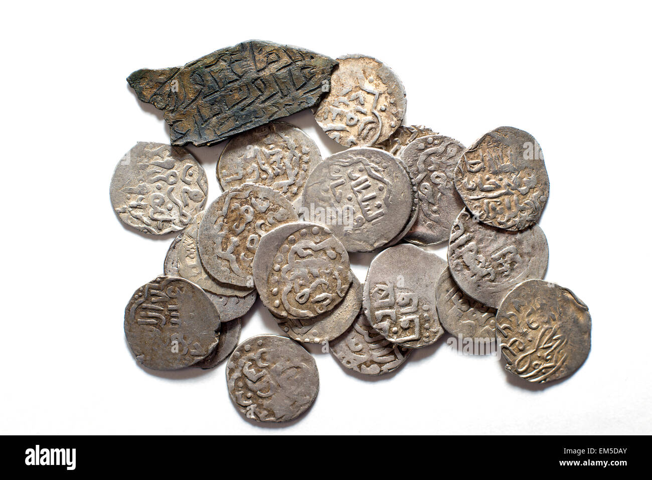 Many ancient Silvers Arabic coins on a white background Stock Photo - Alamy