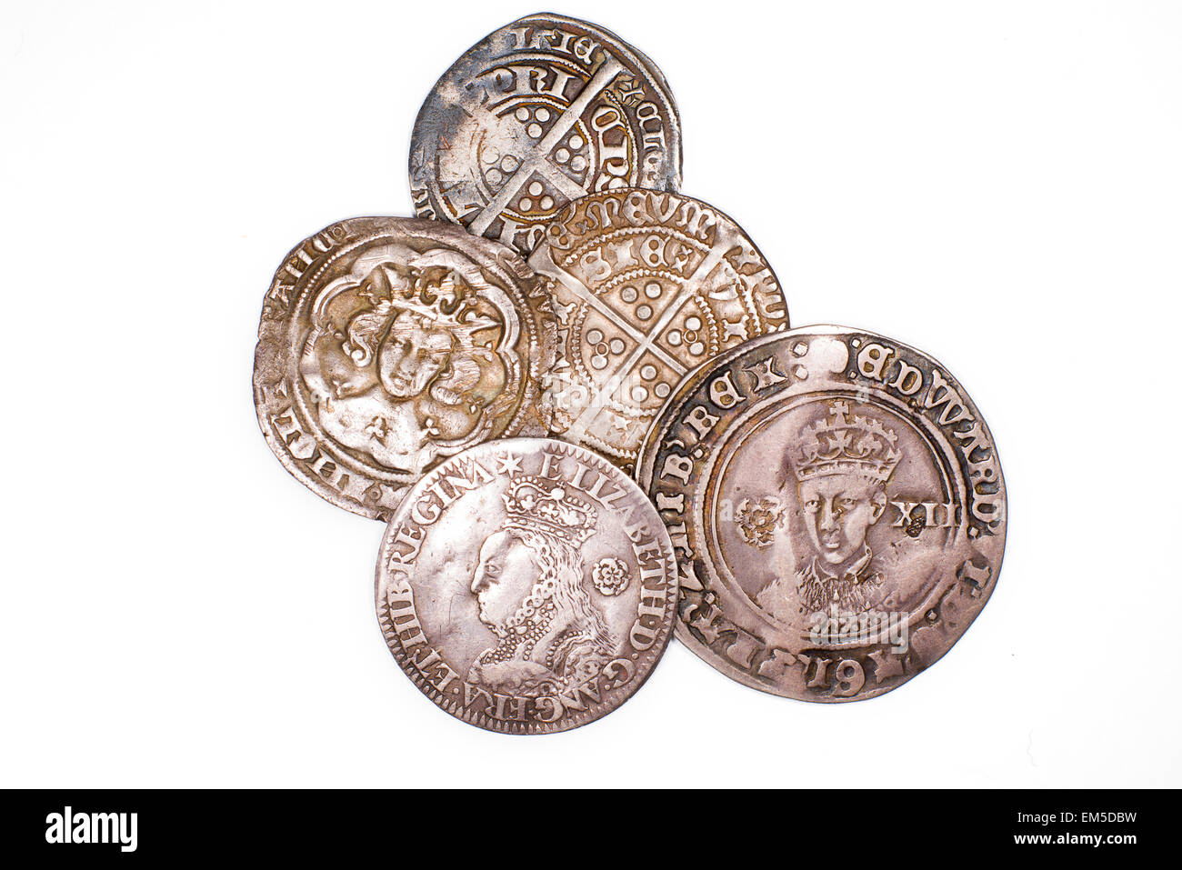 A lot of old silver coins with portraits of kings on a white background ...
