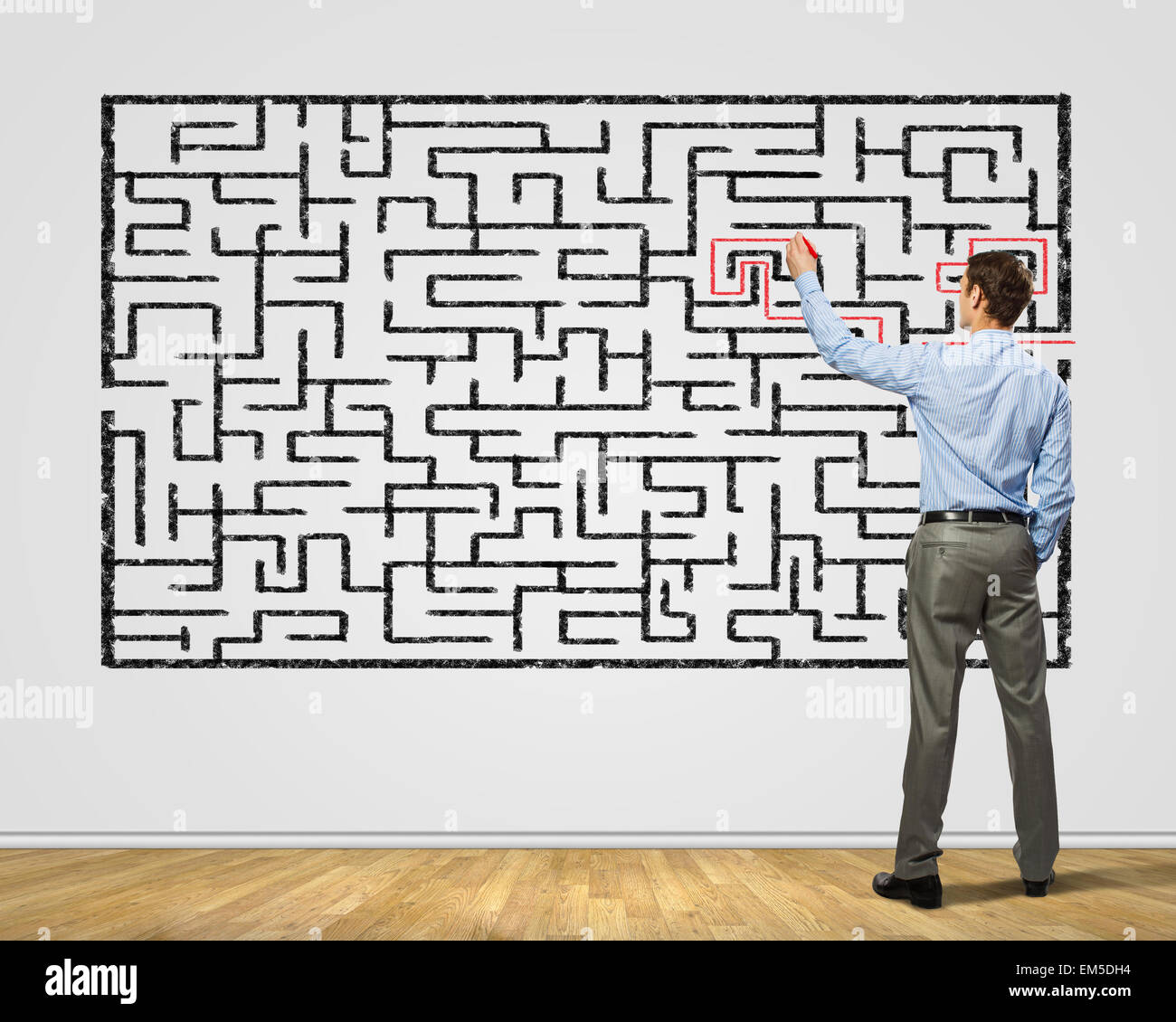 Businessman solving labyrinth problem Stock Photo - Alamy