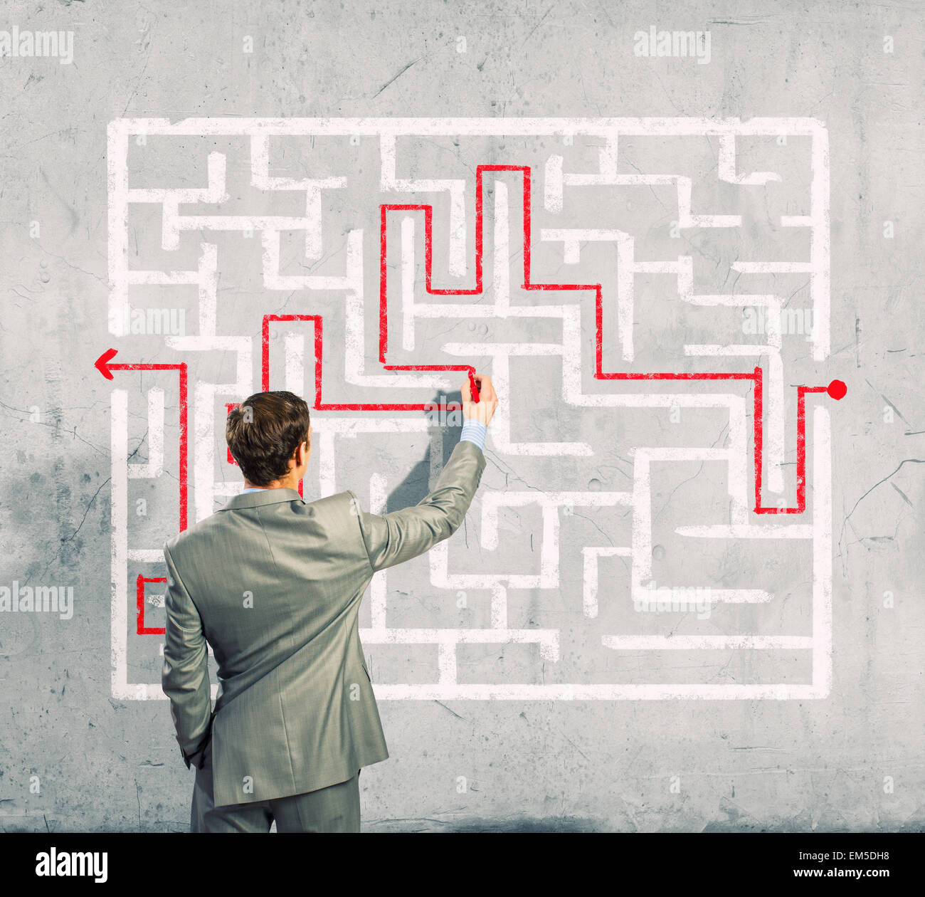 Businessman solving labyrinth problem Stock Photo - Alamy