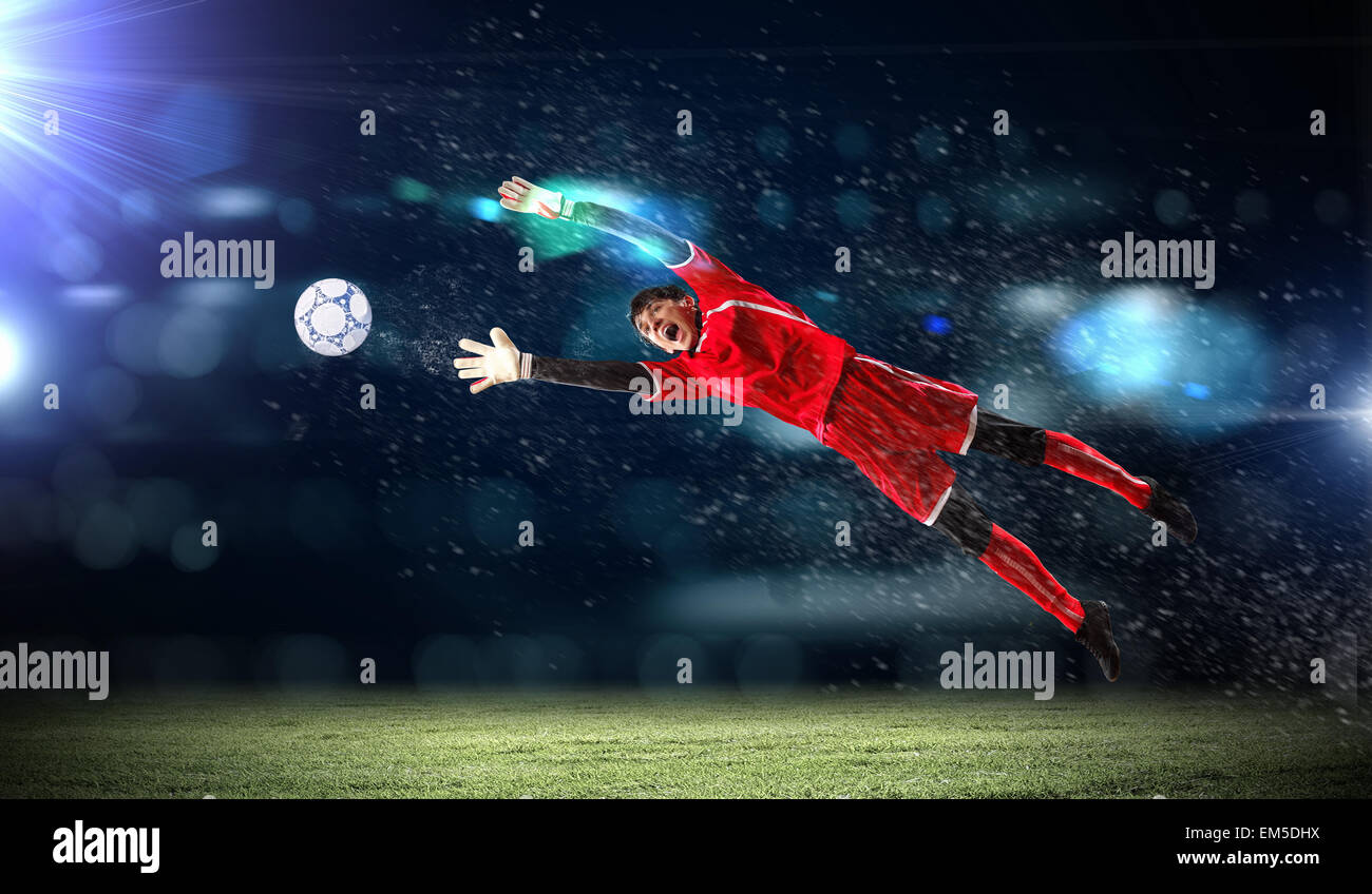 Goalkeeper catches the ball Stock Photo - Alamy