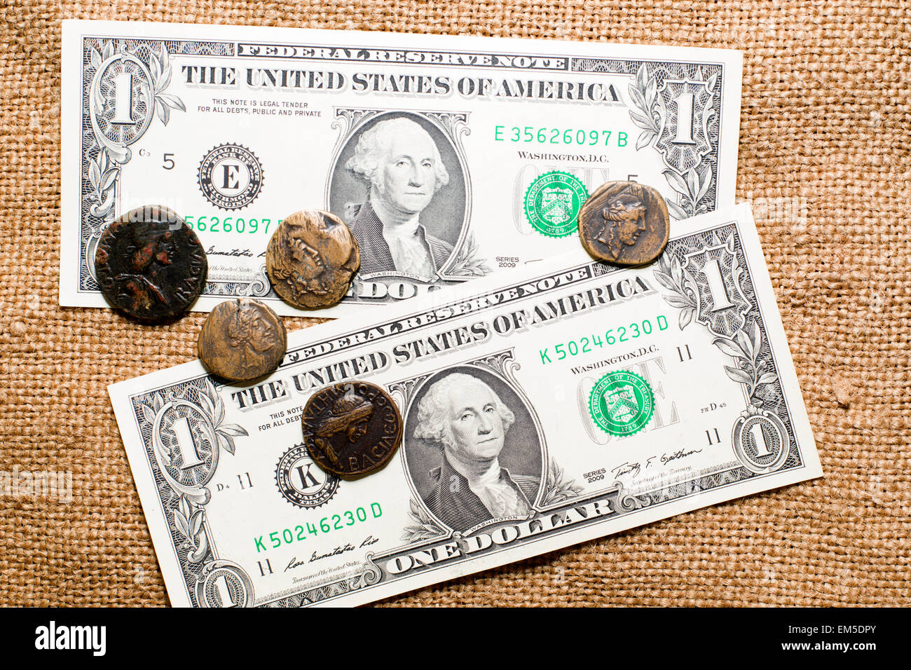 Ancient coin with portrait of emperor and dollar notes on sacking Stock ...