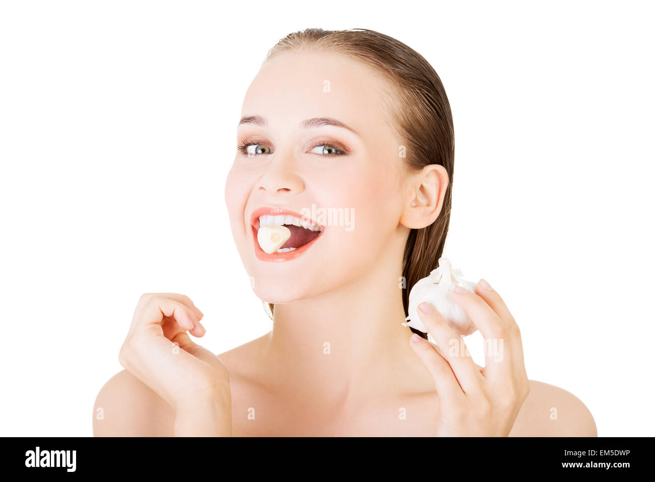Young beautiful woman eating garlic. Healthy eating concept Stock Photo ...