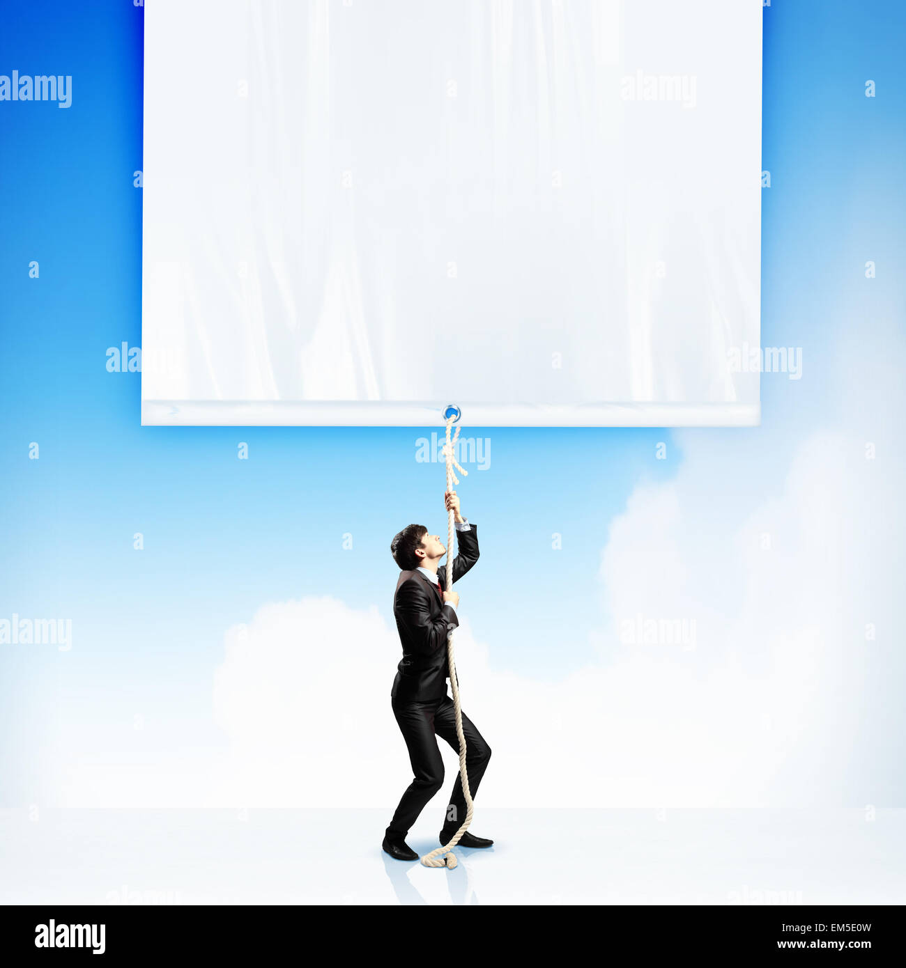 Businessman pulling blank banner Stock Photo - Alamy