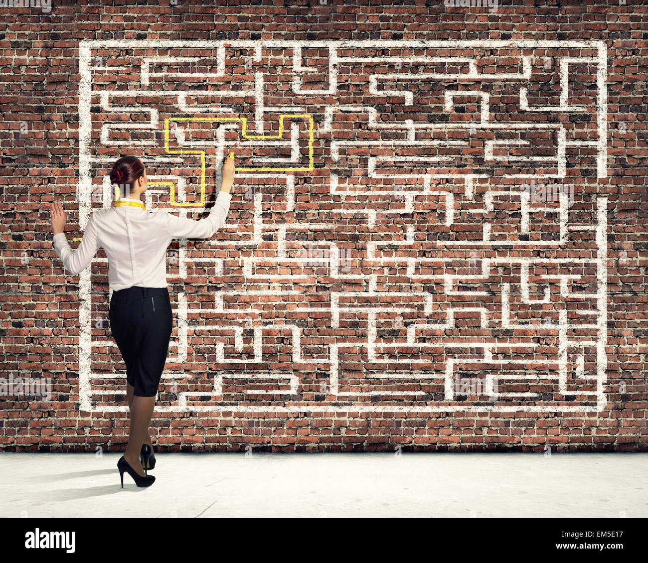 Businesswoman solving maze problem Stock Photo - Alamy