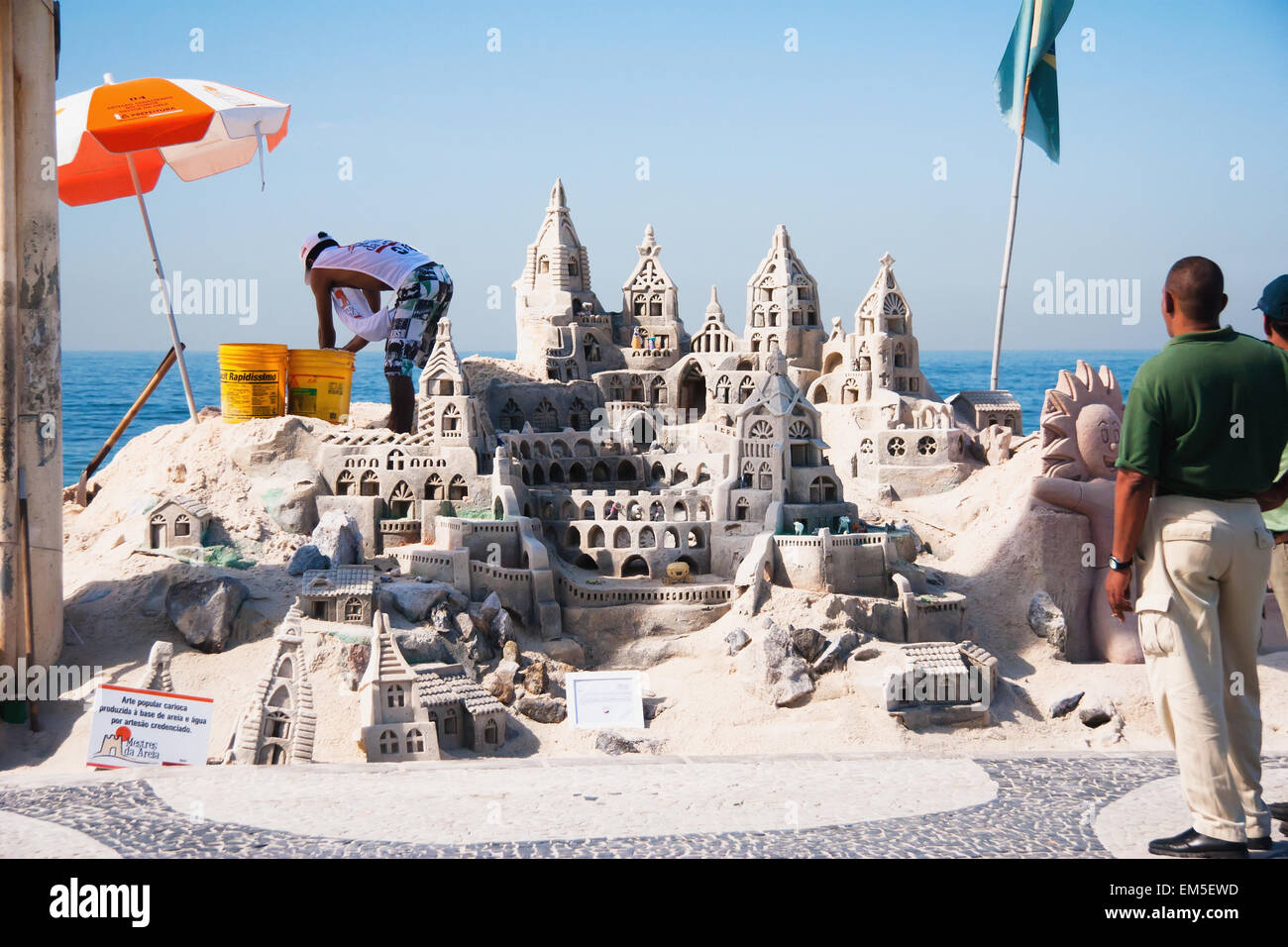 Man building sandcastle on the beach hi-res stock photography and ...