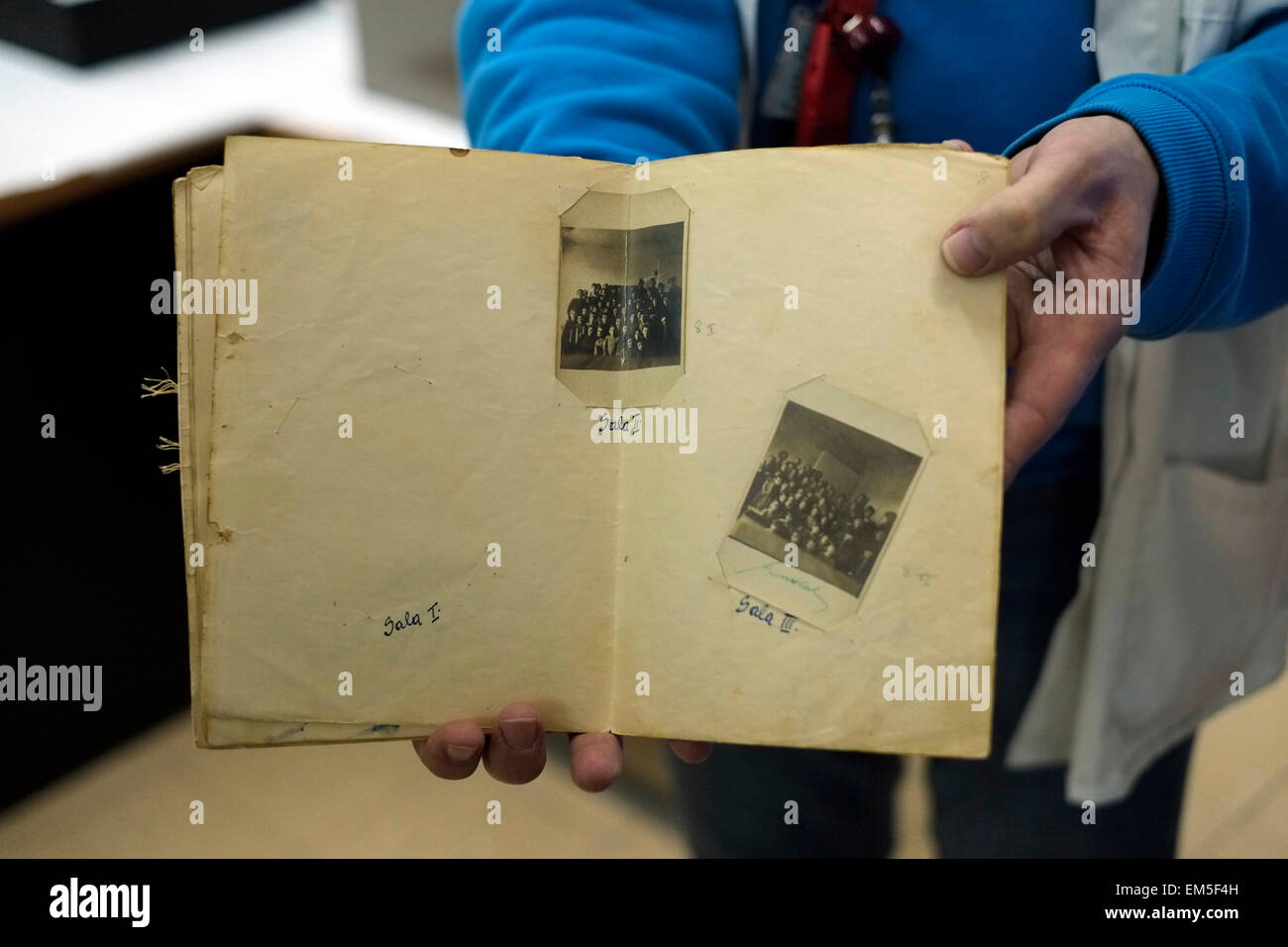 A Yad Vashem researcher shows an old diary with photographs depicting ...