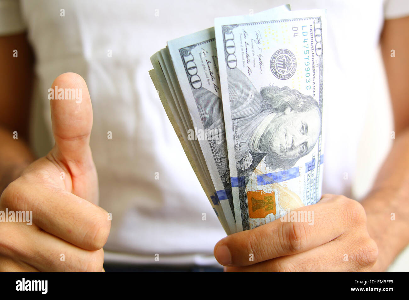 Winner showing profits. spread of cash. currency Stock Photo - Alamy