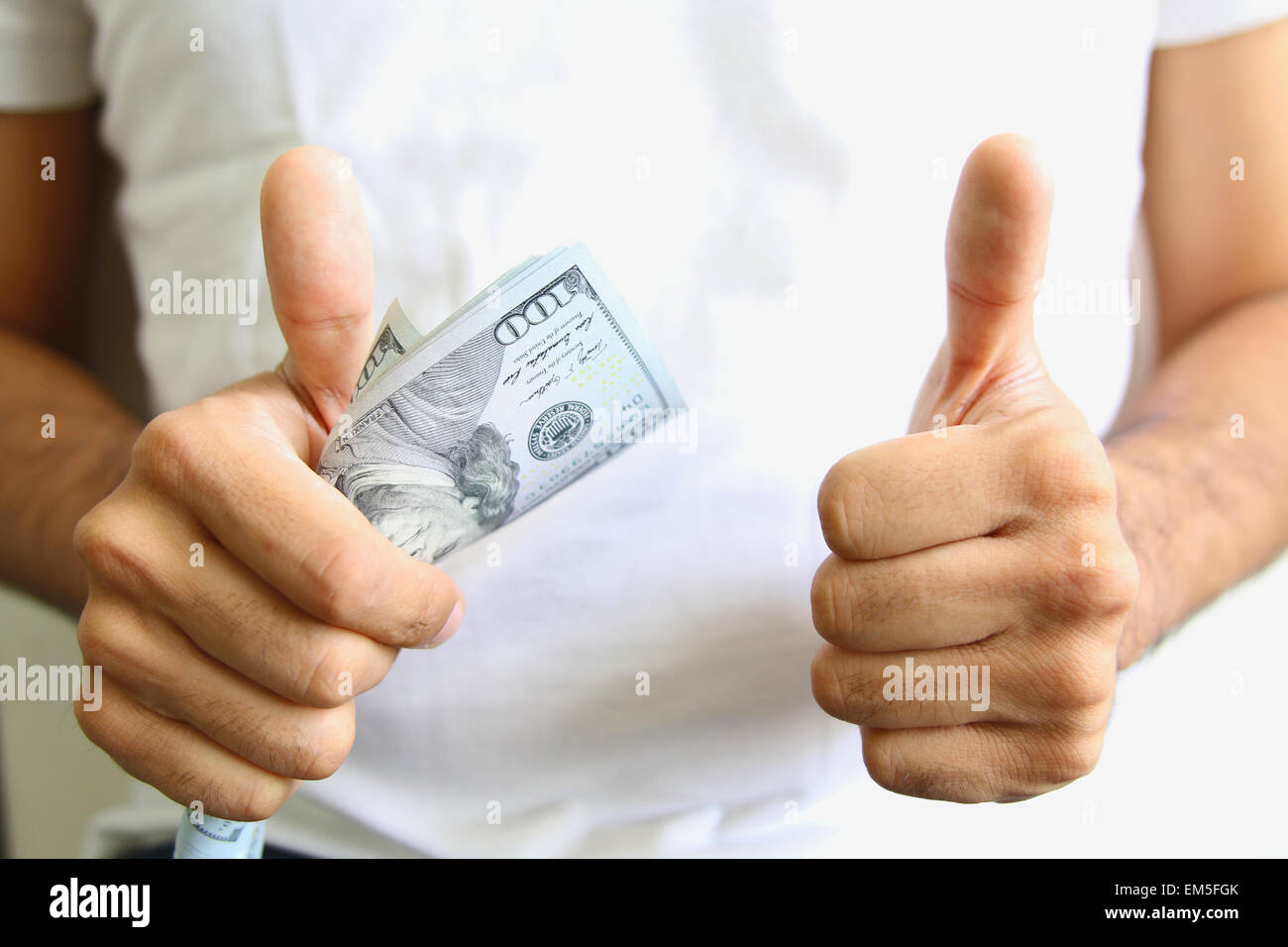 Winner showing profits. spread of cash. currency Stock Photo - Alamy