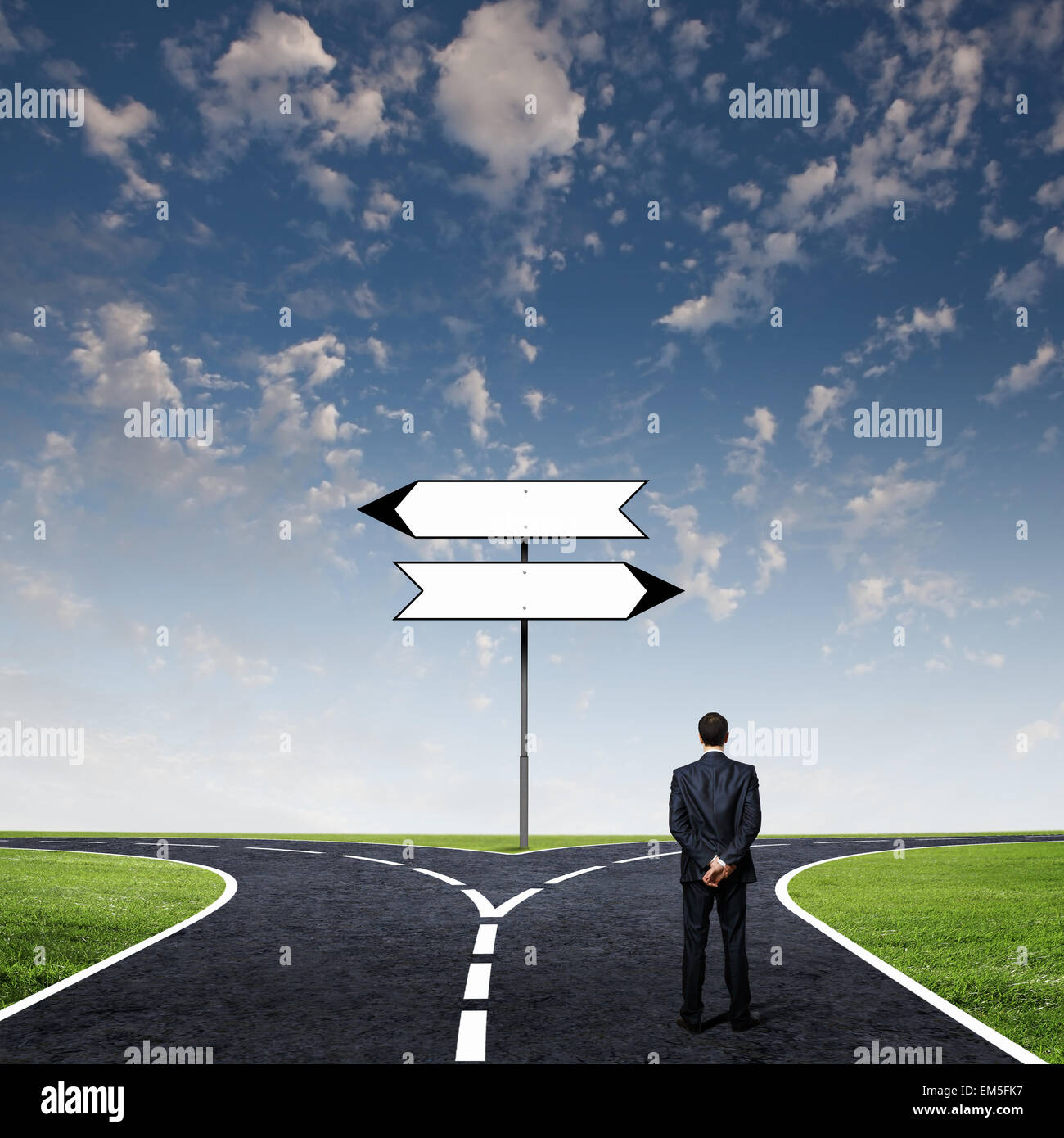 Businessman at crossroads Stock Photo - Alamy