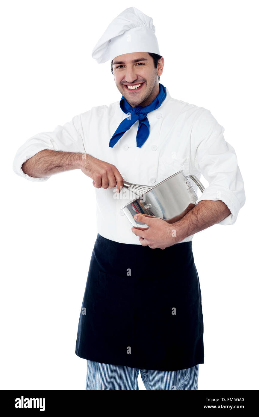 Experienced male chef using egg beater Stock Photo - Alamy