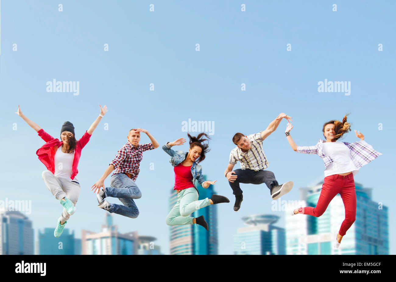 group of teenagers jumping Stock Photo - Alamy